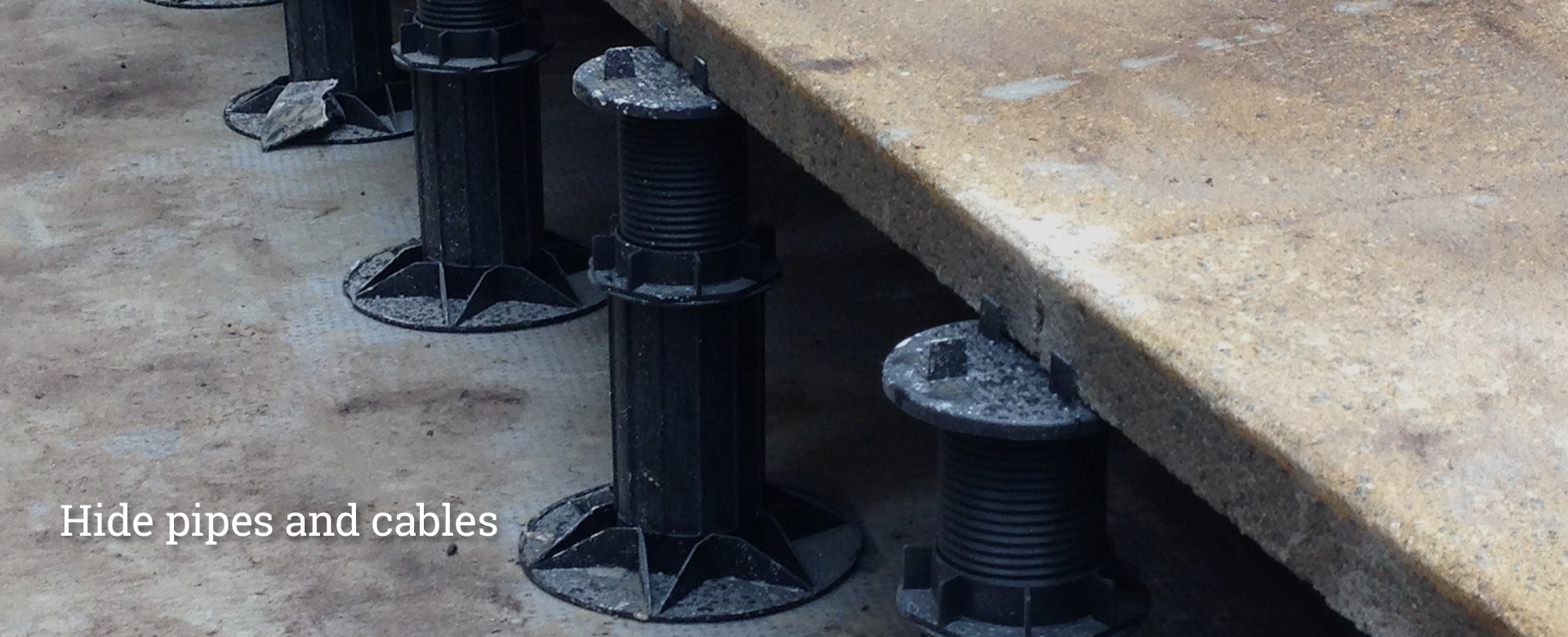 An image showing how paving pedestals can be used to hide pipes and ...