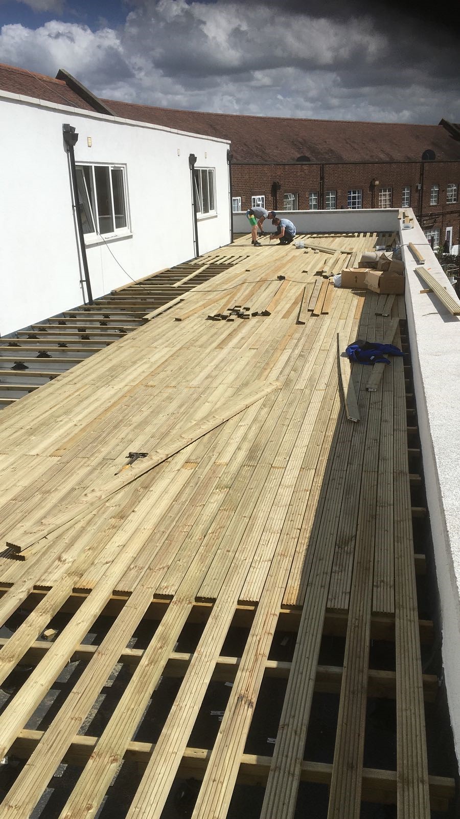 An image of a decking installation in progress - Wallbarn